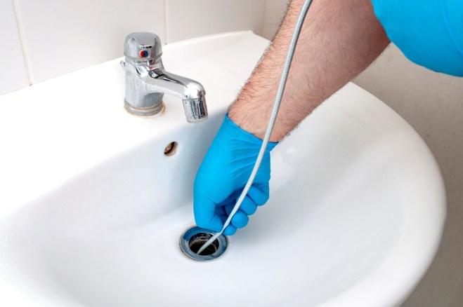 How to Snake a Drain and Clear Clogs in Sinks and Tubs - Bob Vila